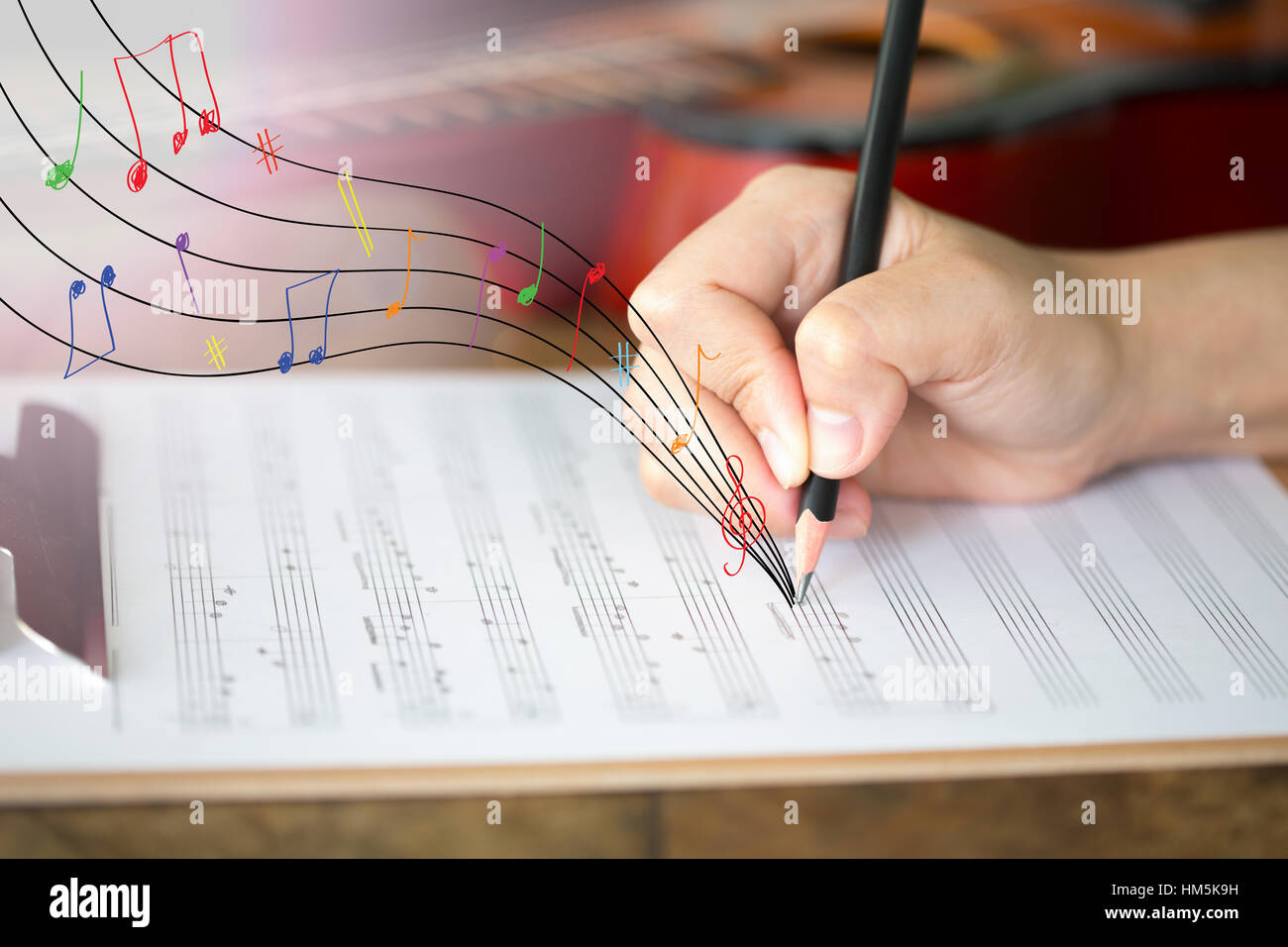 Hand with pencil and music sheet Stock Photo - Alamy