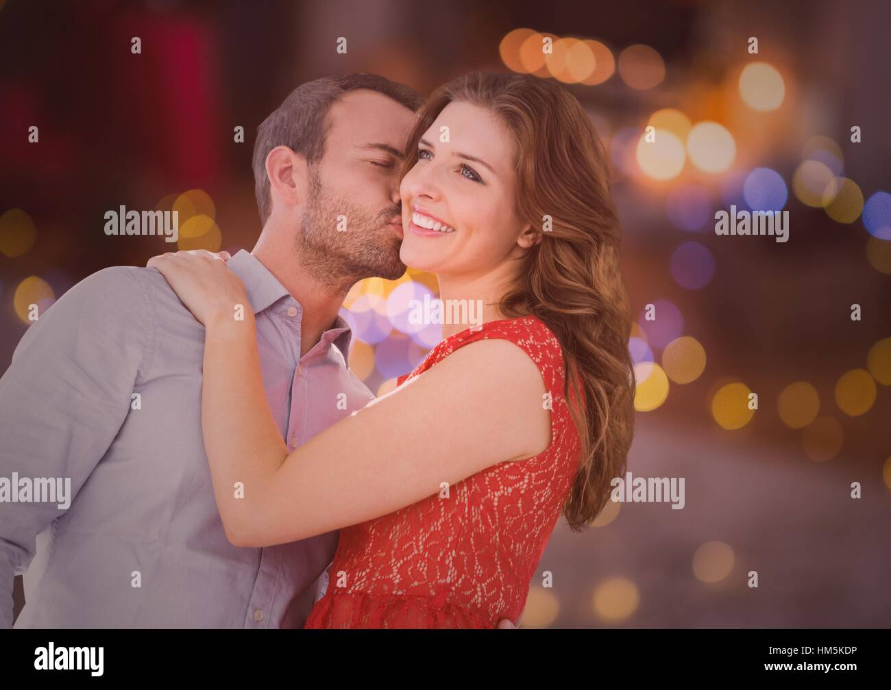 Man kissing woman on cheeks Stock Photo - Alamy