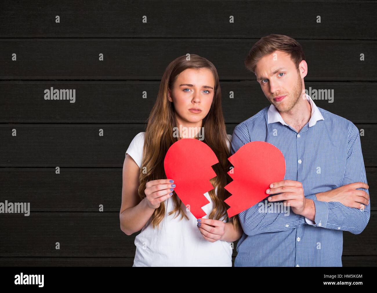 Portrait of sad couple holding broken hearts Stock Photo - Alamy