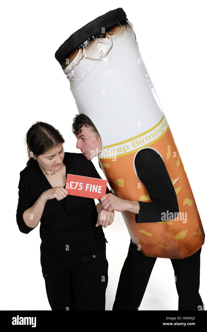 A man dressed as a cigarette but container gives a fine to a litter ...