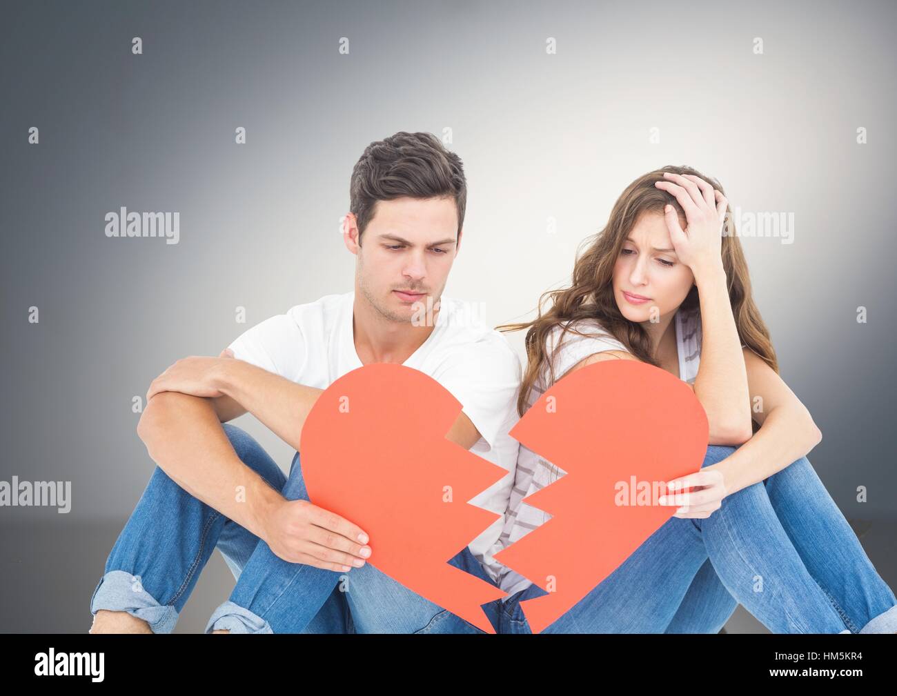 Sad couple holding broken hearts Stock Photo - Alamy
