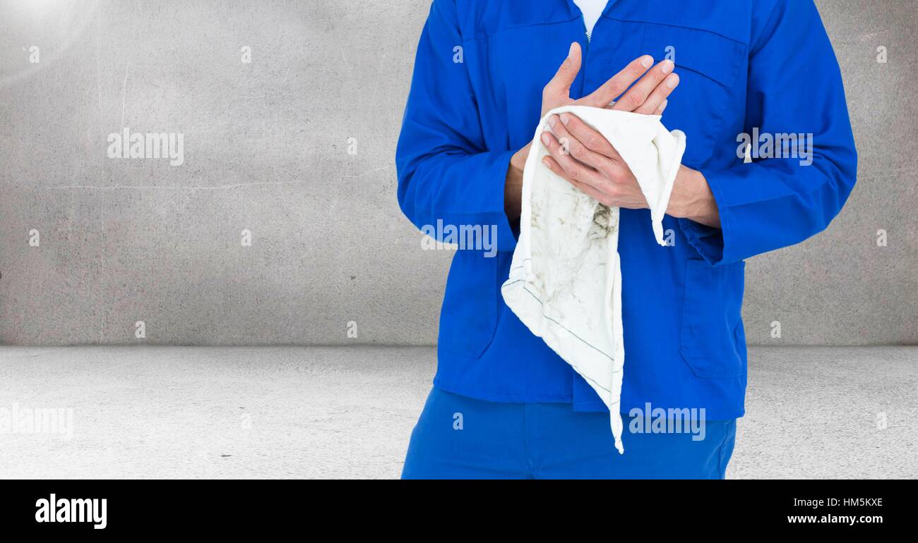 Mechanic wiping his hand with cloth Stock Photo - Alamy