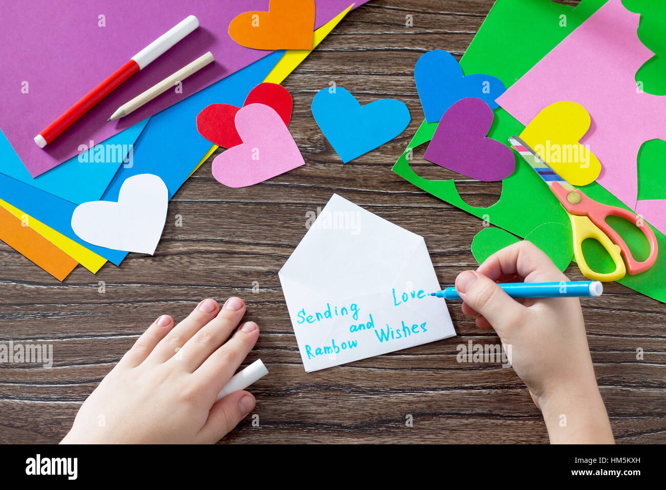 The child makes the inscription paper items. Greeting card with paper ...