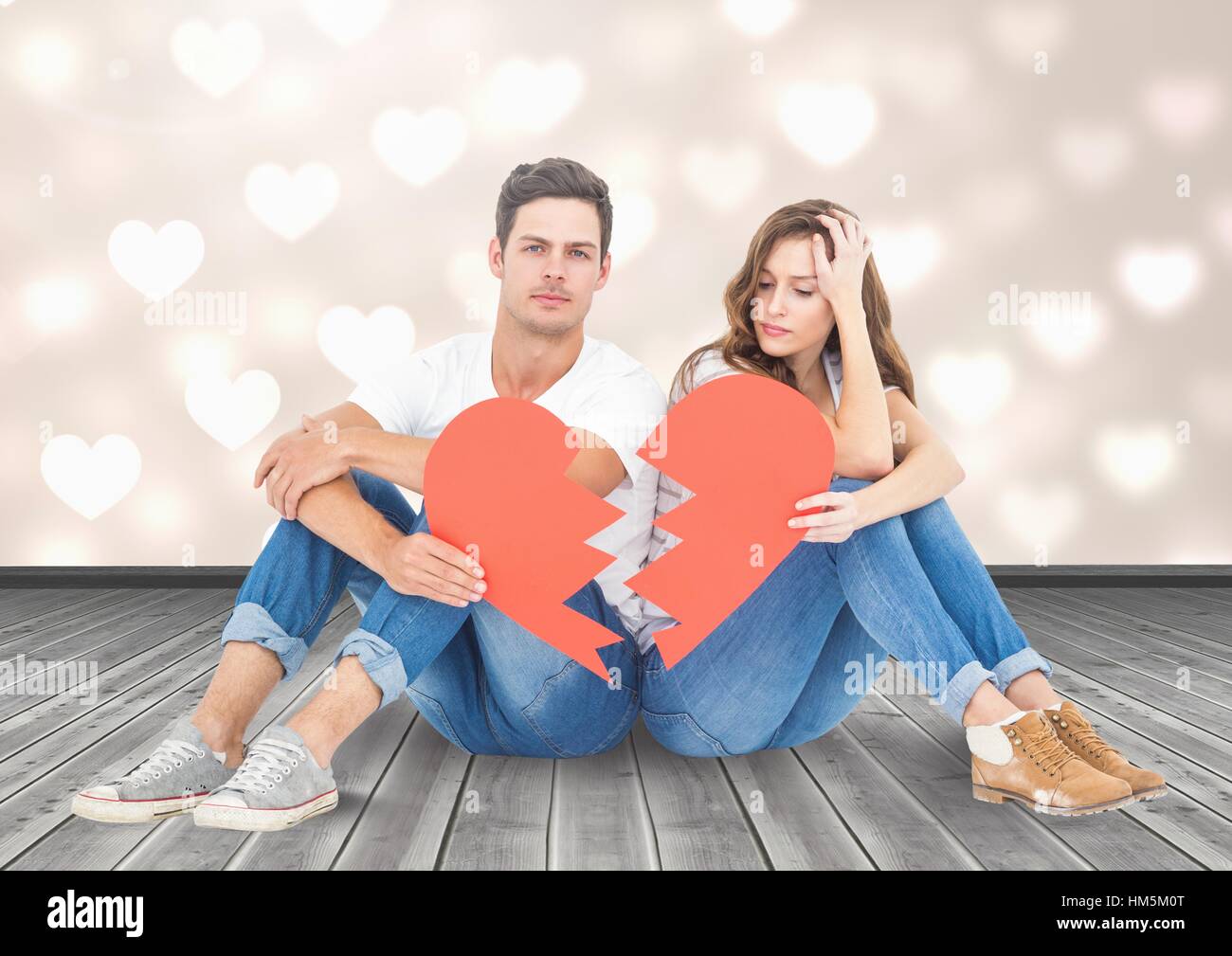 Sad couple holding broken heart Stock Photo - Alamy