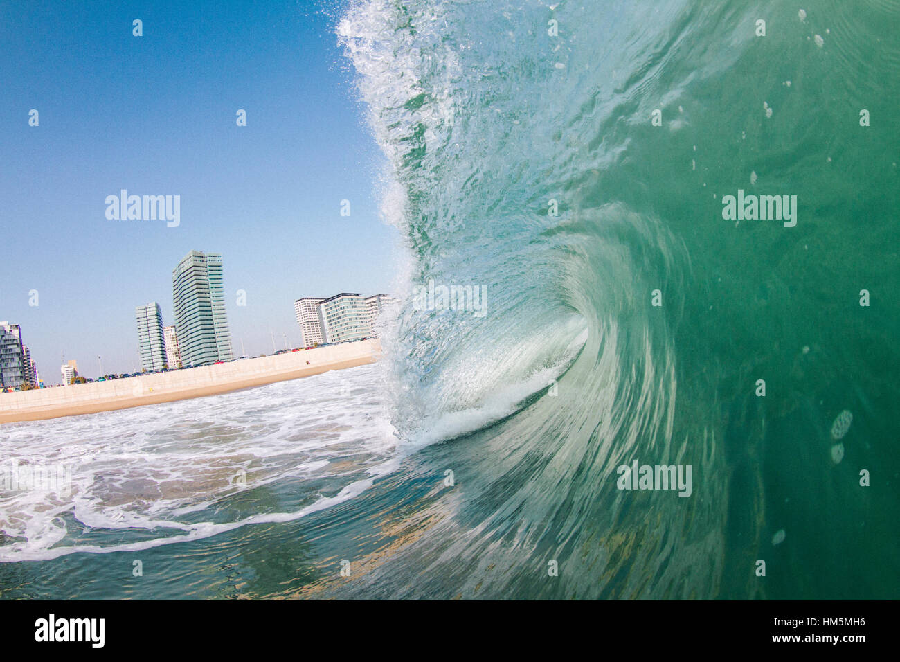 Close-up of wave against residential buildings Stock Photo - Alamy