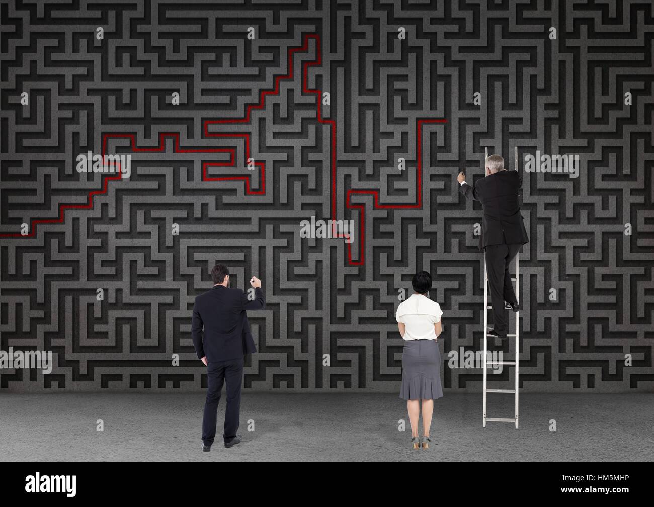 Business people looking at maze Stock Photo - Alamy