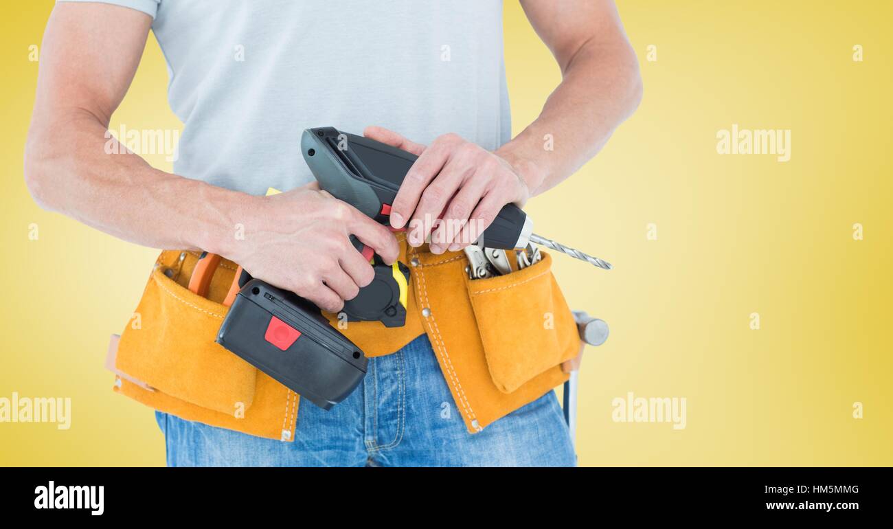 Mid-section of handy man with tool belt and drill Stock Photo - Alamy