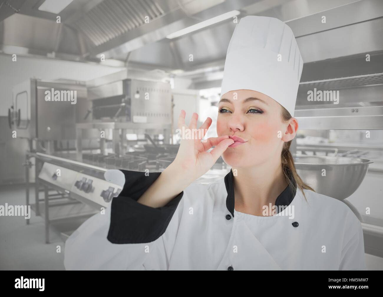 Female chef tasting food in kitchen Stock Photo - Alamy