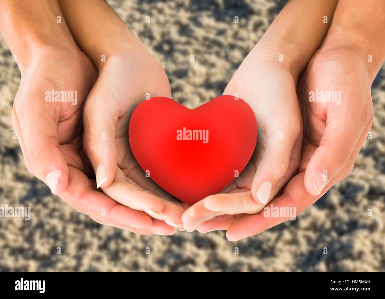 Couple holding heart shape in cupped hands Stock Photo - Alamy