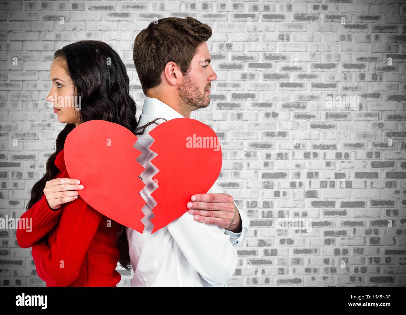 Depressed couple holding broken heart Stock Photo - Alamy