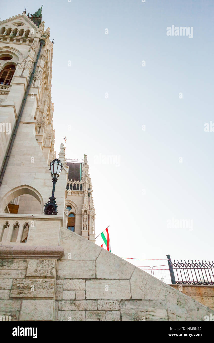 National flags handing on Hungarian Parliament building located at the bank of the Dunabe river ...