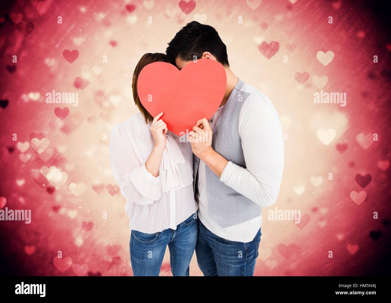 Romantic couple holding heart shape and kissing each other Stock Photo ...