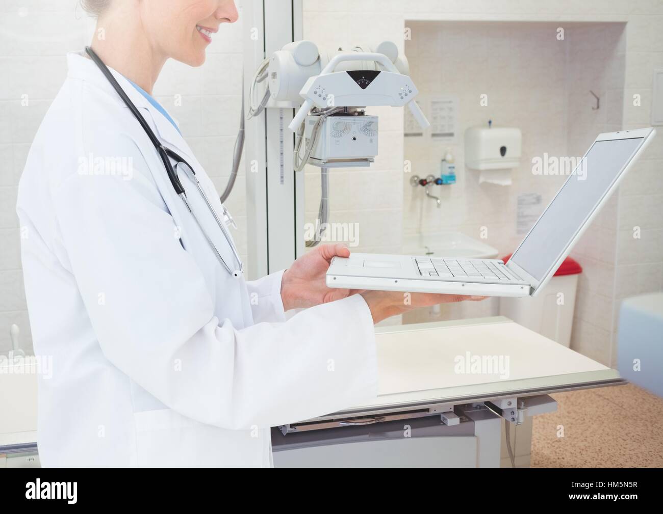 Mid section of doctor using laptop Stock Photo - Alamy