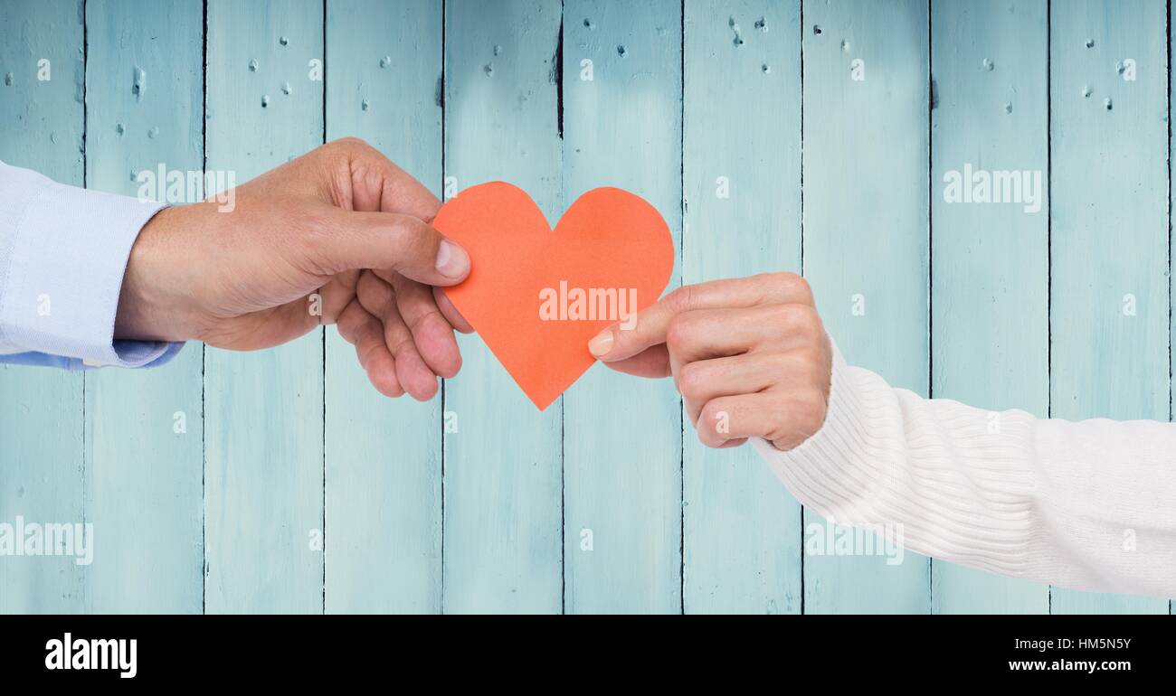 Couple hand holding heart Stock Photo - Alamy