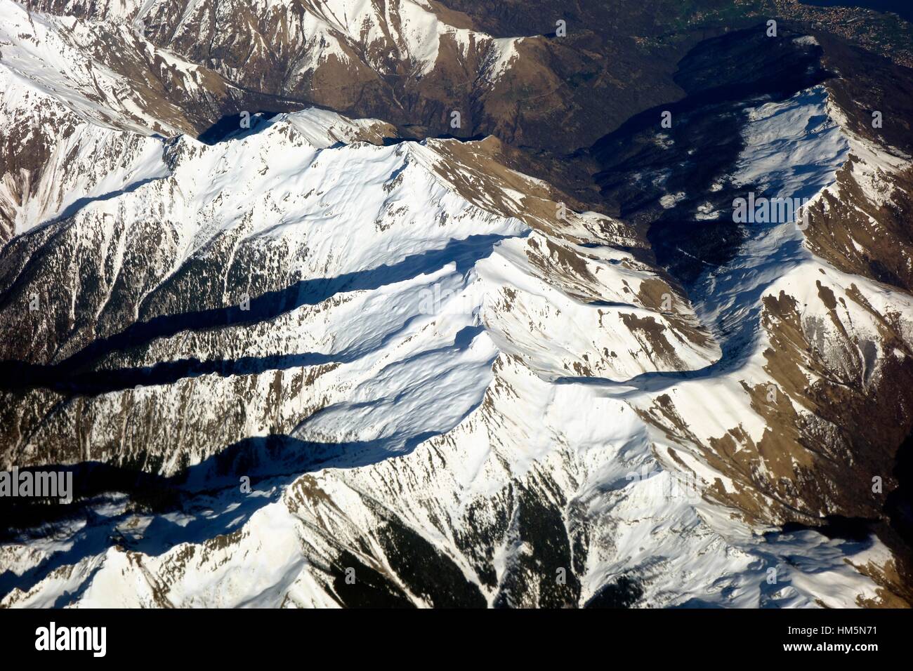 Snow covered mountain peaks high in the Alps Stock Photo - Alamy
