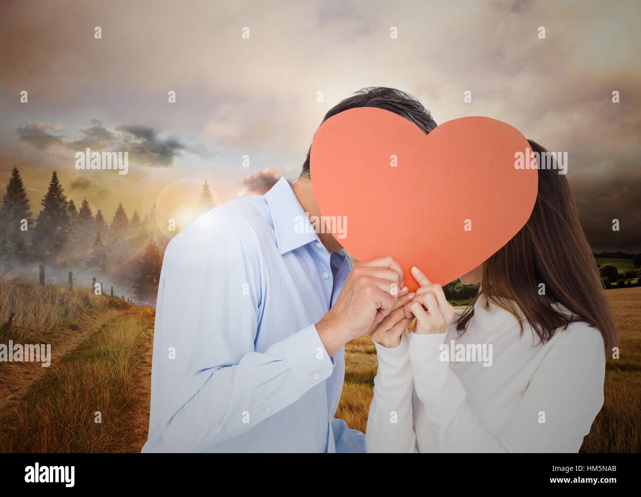 Woman standing behind man kissing hi-res stock photography and images ...