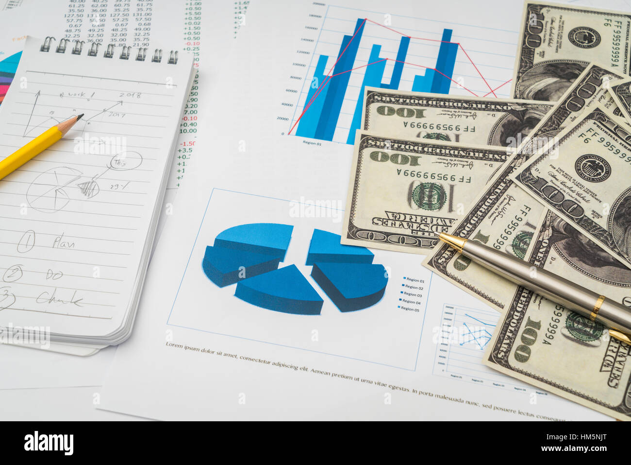 Financial charts on the table with dollars banknotes Stock Photo - Alamy
