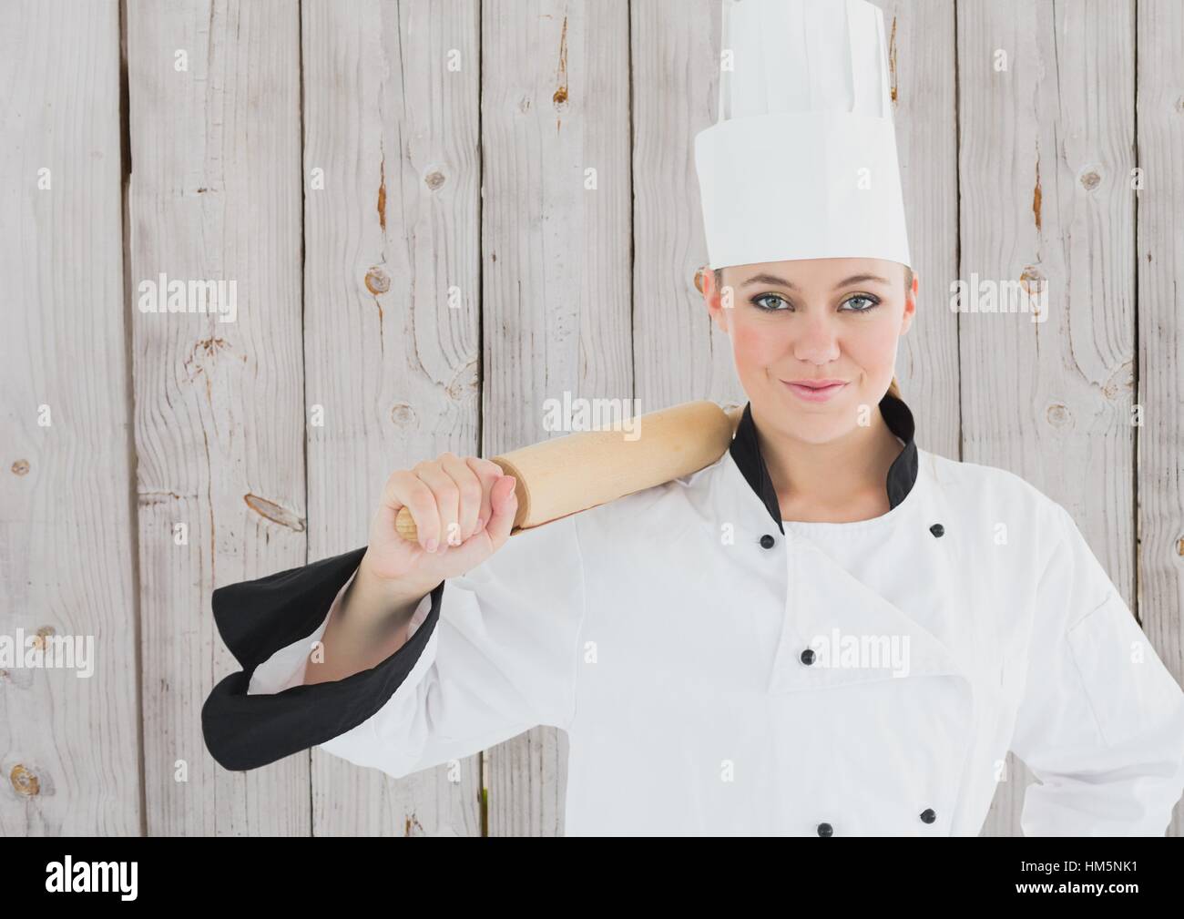 Portrait of smiling female chef holding rolling pin Stock Photo - Alamy
