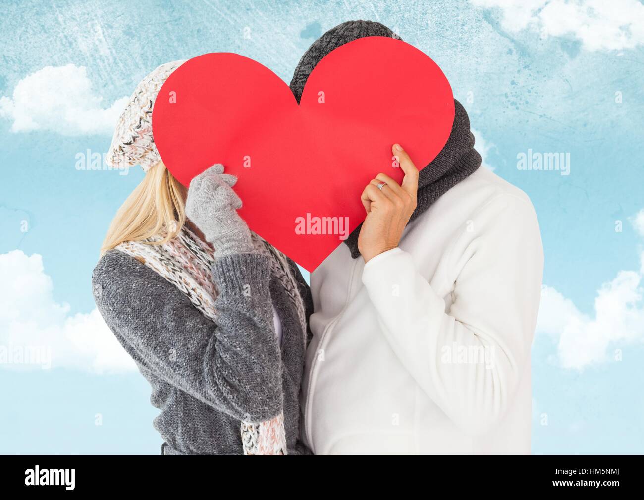Couple hiding their face behind red heart Stock Photo - Alamy