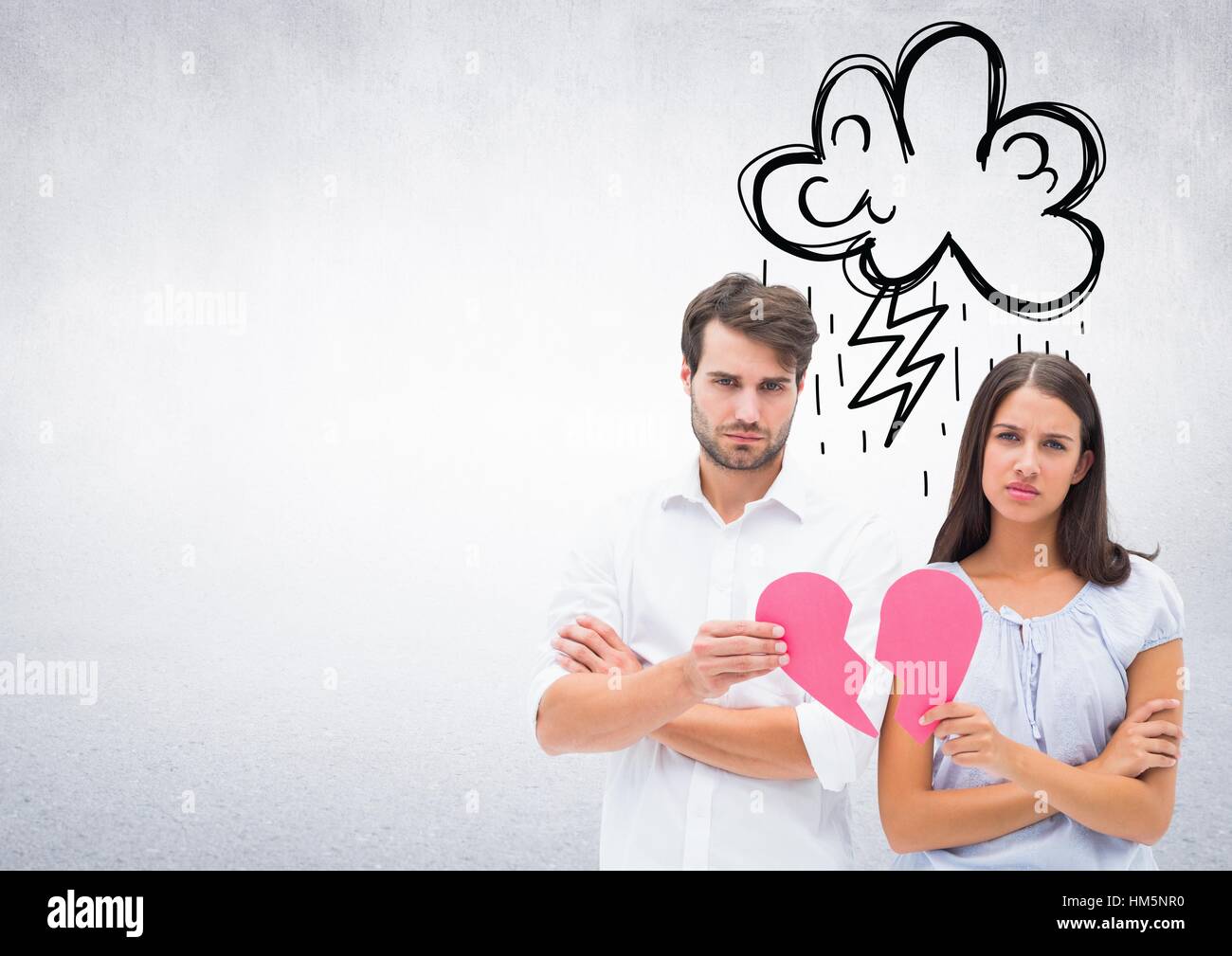 Depressed couple holding broken heart against white background Stock ...