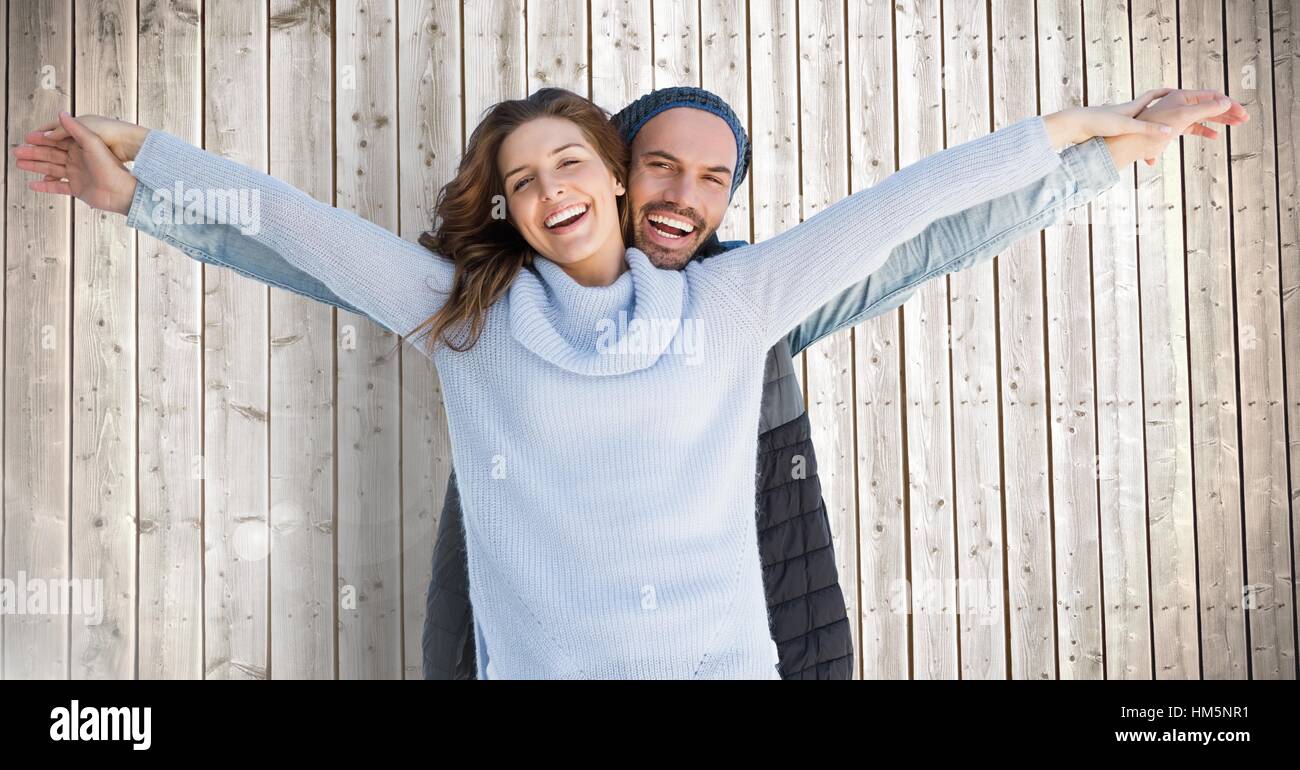Portrait of happy couple standing with arms outstretched Stock Photo ...
