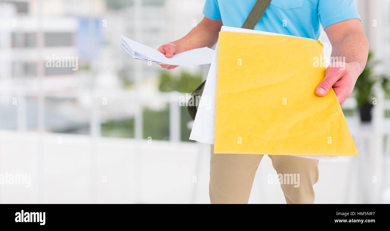 Delivery man holding couriers Stock Photo - Alamy