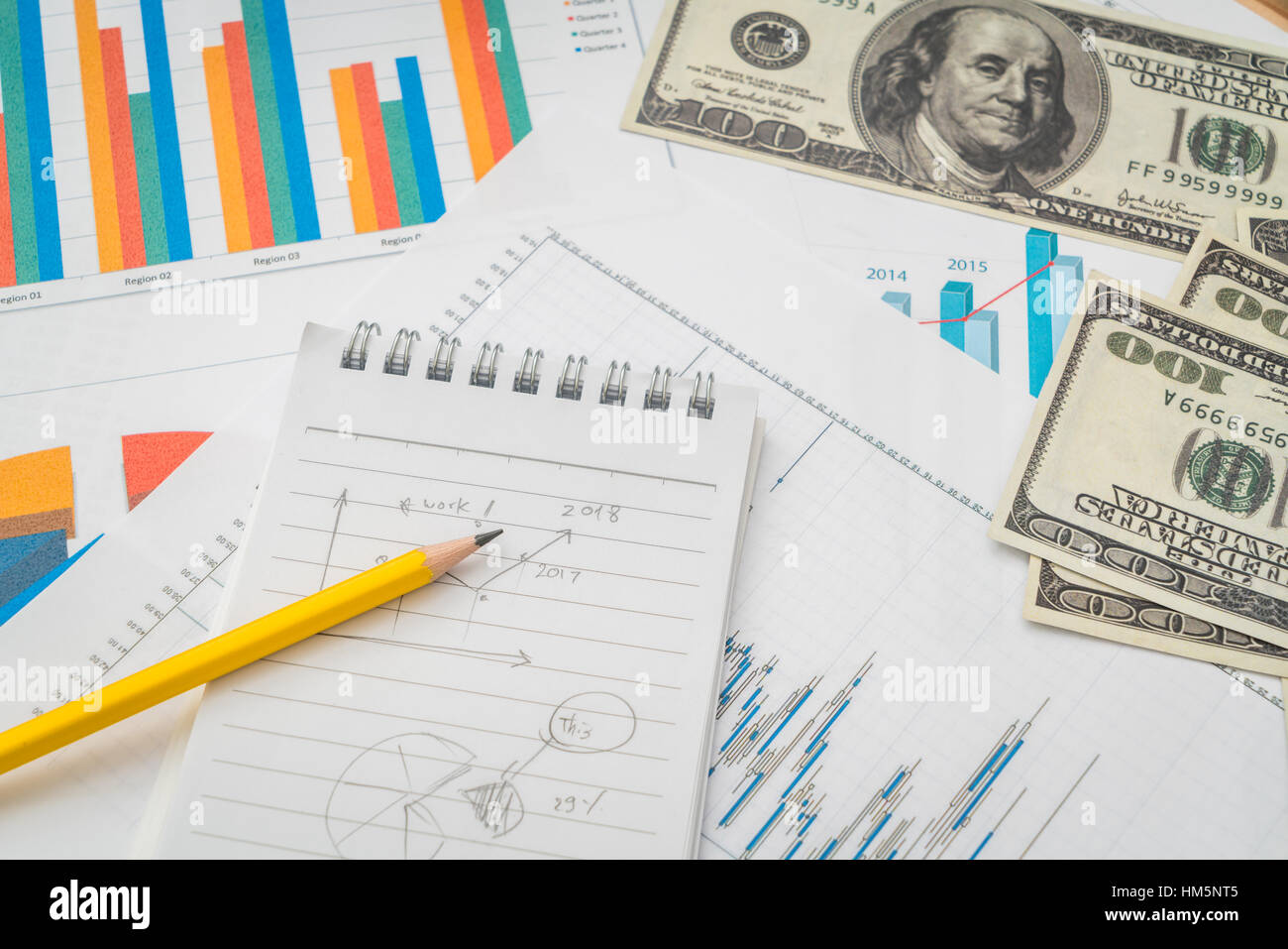 Financial charts on the table with dollars banknotes Stock Photo - Alamy