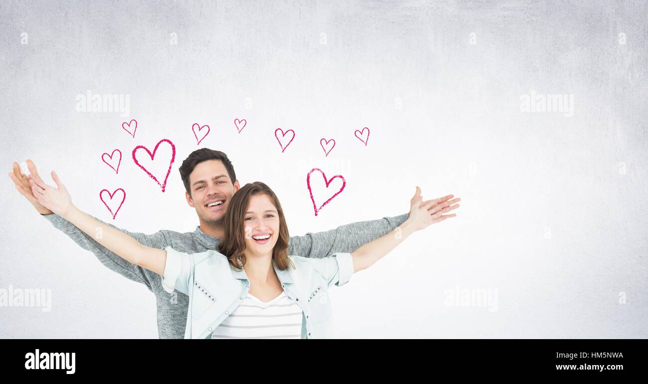 Portrait of couple standing with arms outstretched Stock Photo - Alamy