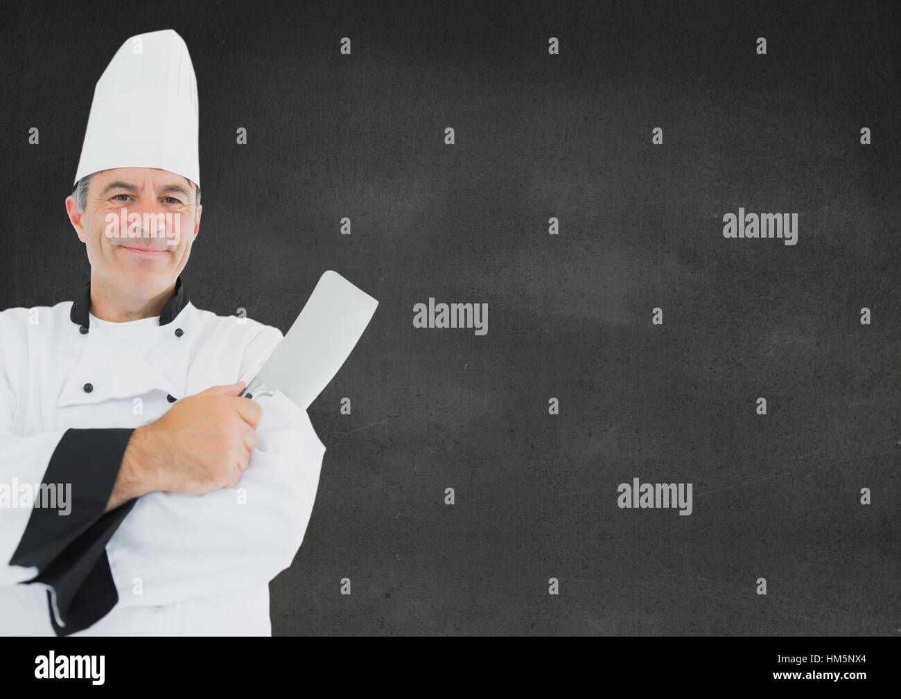Composite image of smiling chef holding a knife Stock Photo - Alamy