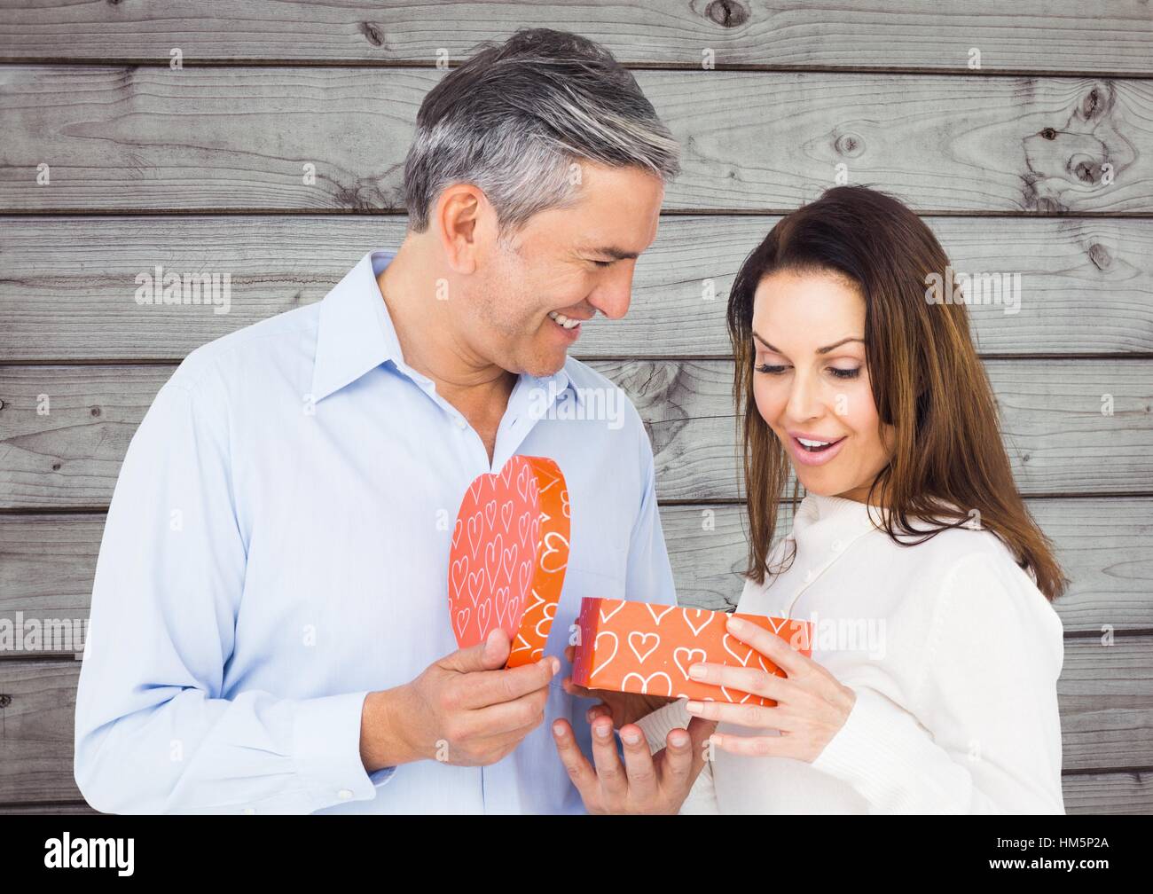 Excited woman receiving gift from man Stock Photo - Alamy