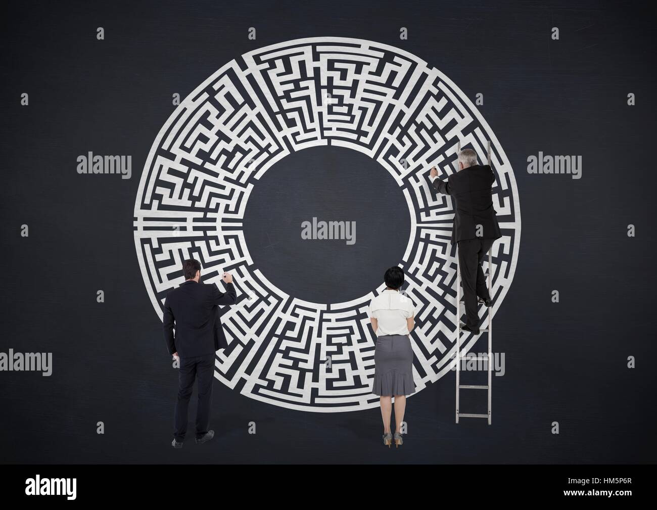 Businesspeople writing on maze wall Stock Photo - Alamy