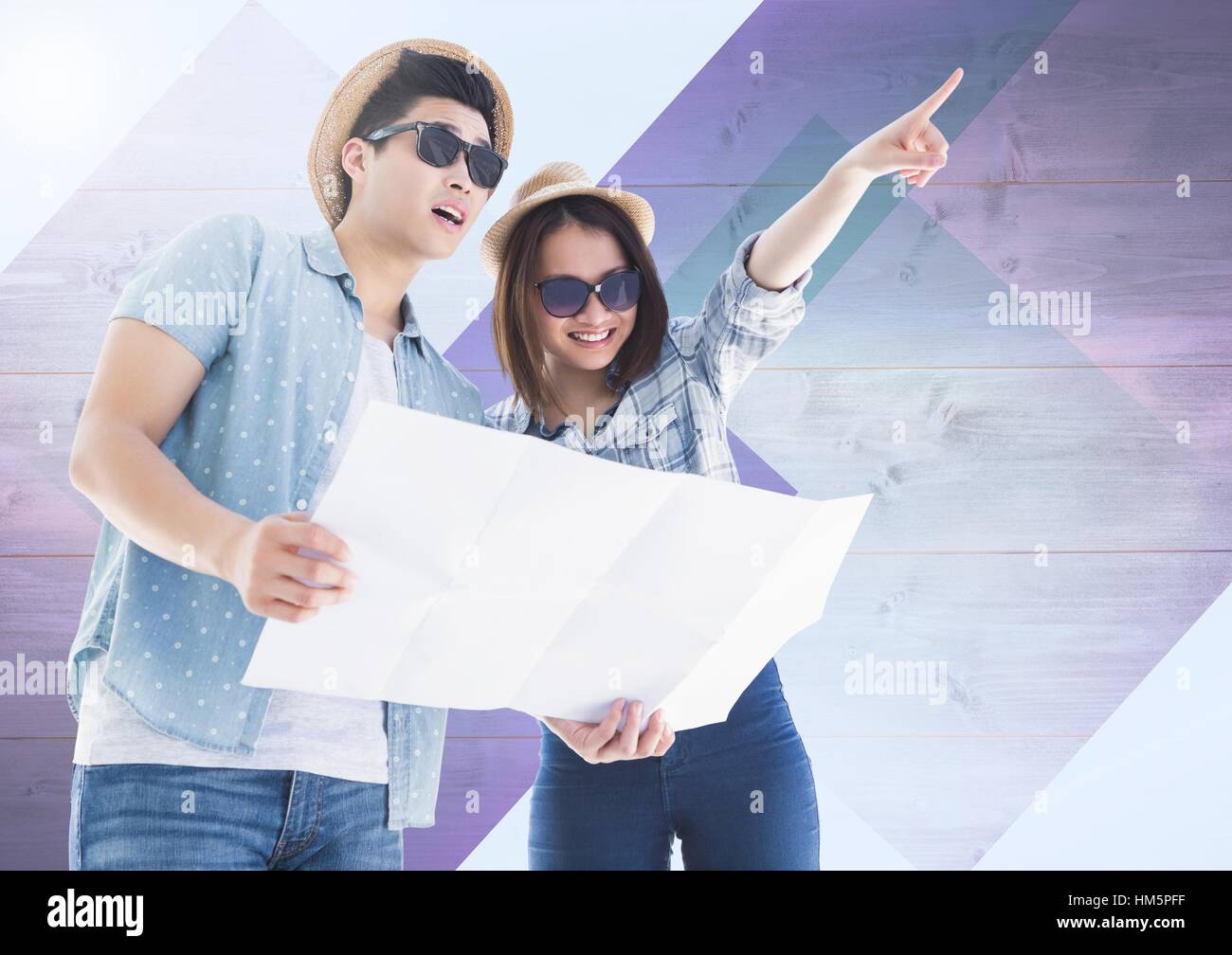 Couple pointing and holding a map Stock Photo - Alamy