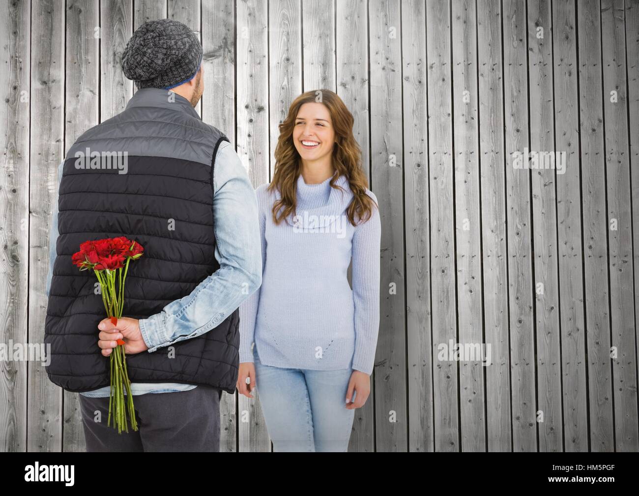 Man hiding flowers behind his back Stock Photo - Alamy