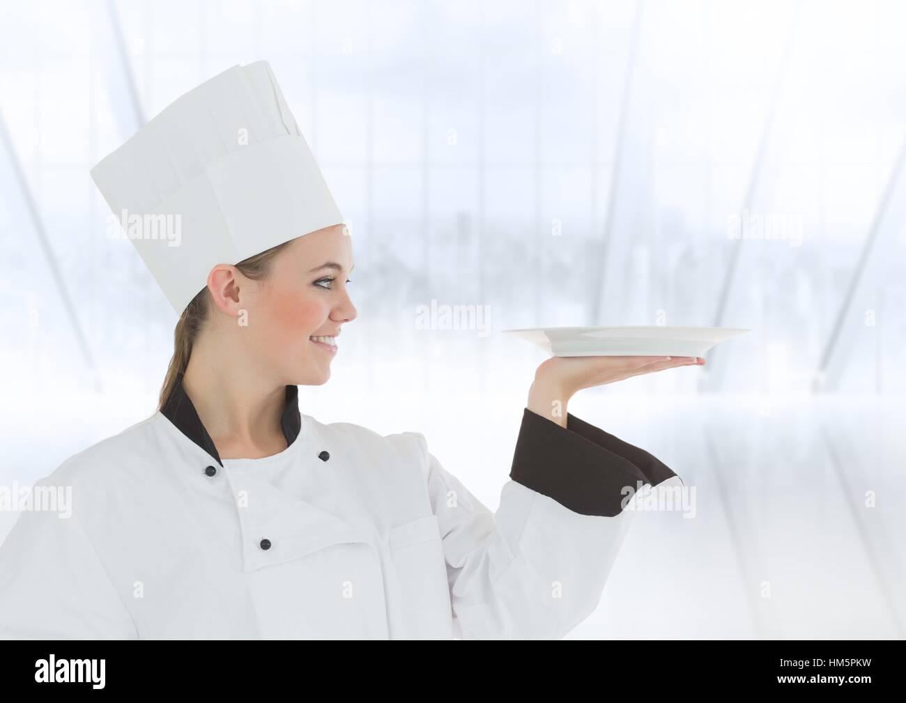 Female chafe holding plate Stock Photo - Alamy