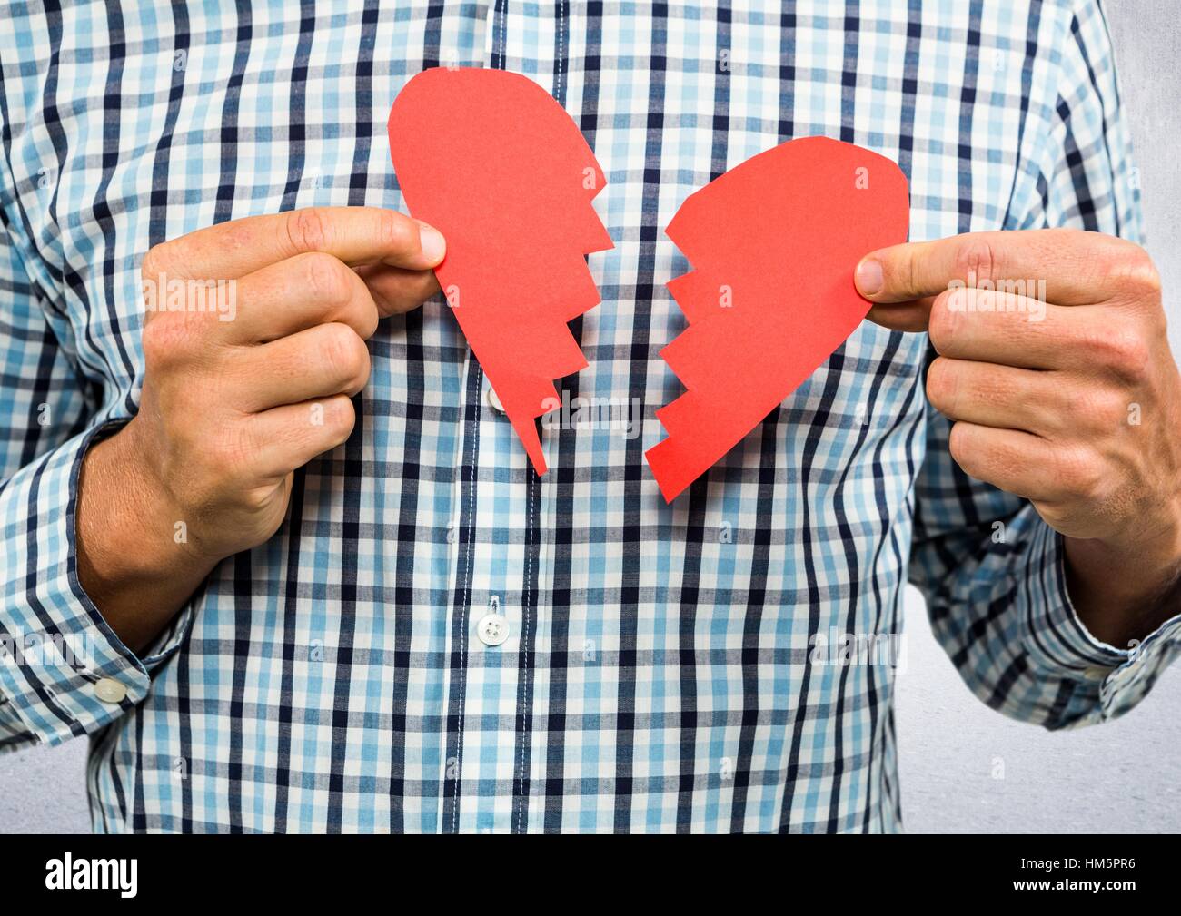 Man holding broken heart Stock Photo - Alamy