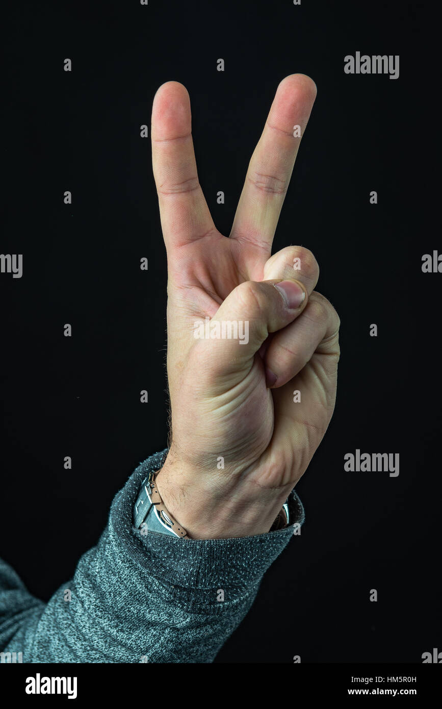 human hand showing signs of victory Stock Photo - Alamy