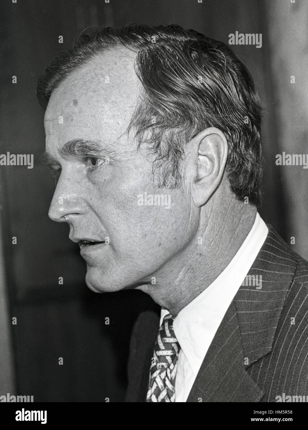United States Ambassador to China George H.W. Bush listens to a ...