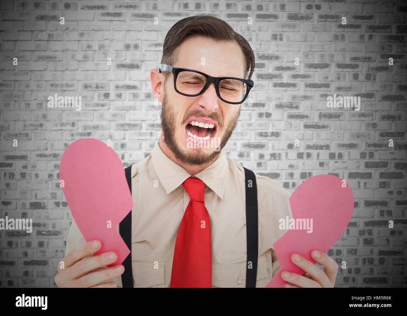 Crying man holding broken heart Stock Photo - Alamy