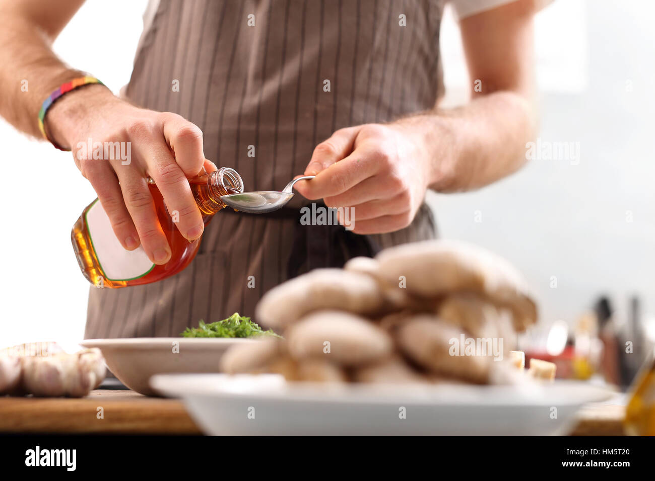Maple syrup, a sweet addition to cooking. The cook pours maple syrup on ...