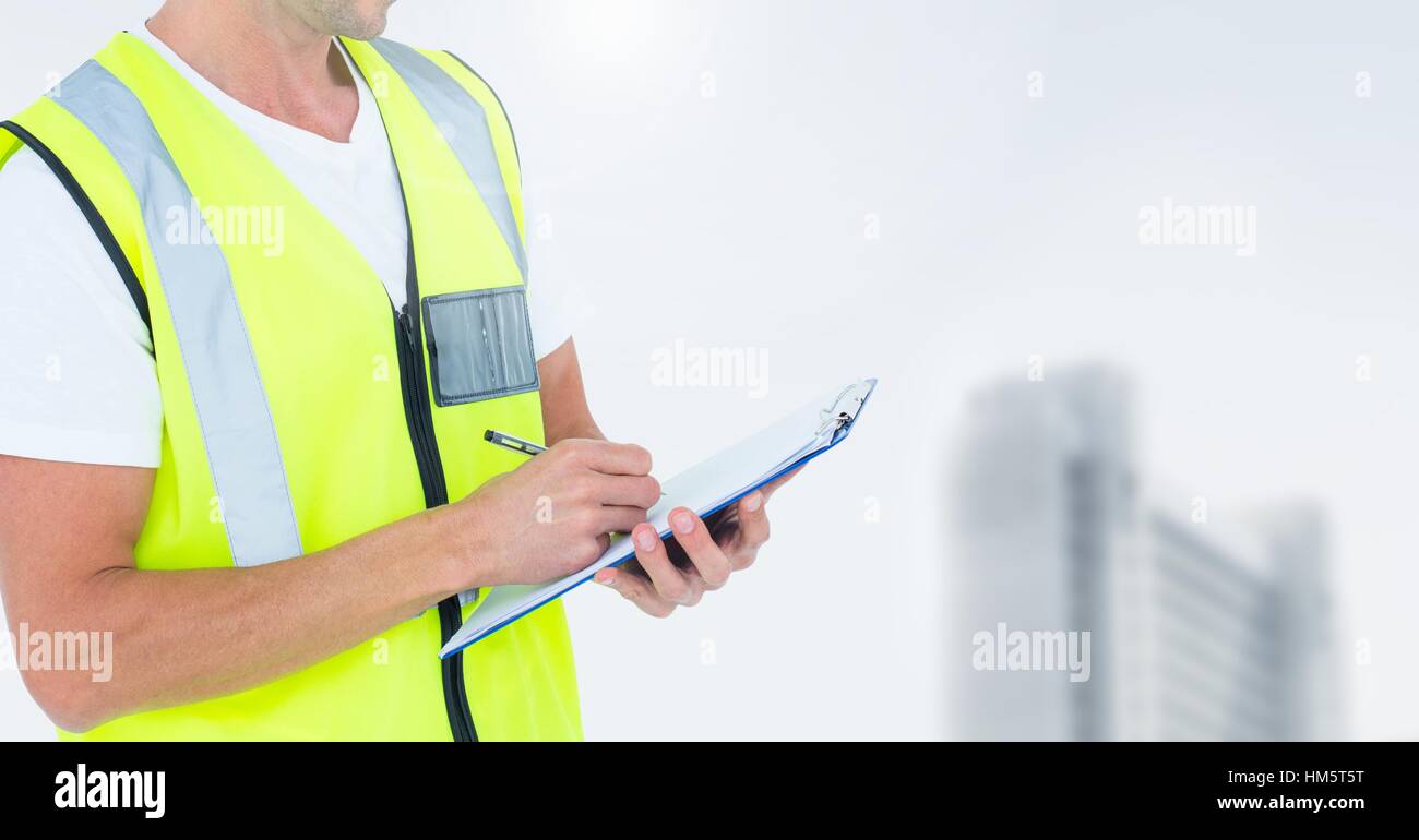 Construction man writing on clipboard against white background Stock ...