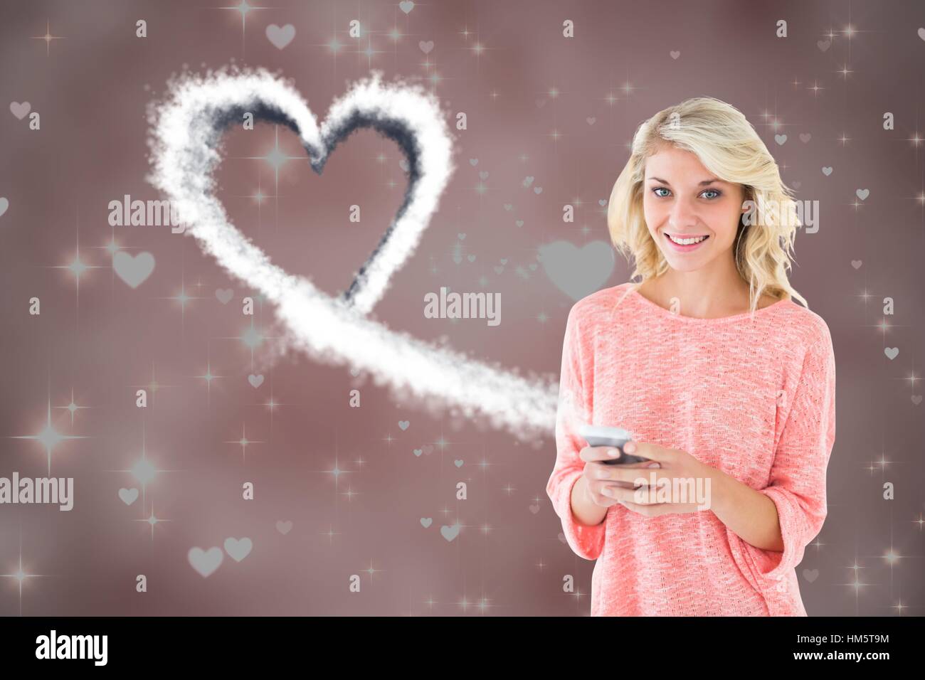Smiling woman texting on mobile phone with digitally generated white ...