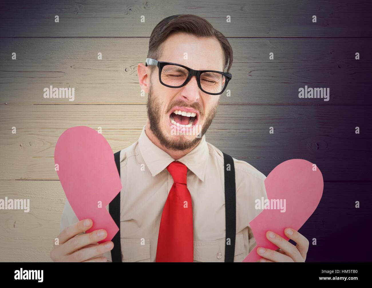 Crying man holding broken heart Stock Photo - Alamy