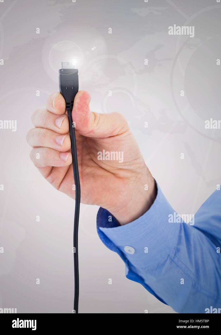 Hand holding computer cable against digital composite background Stock ...