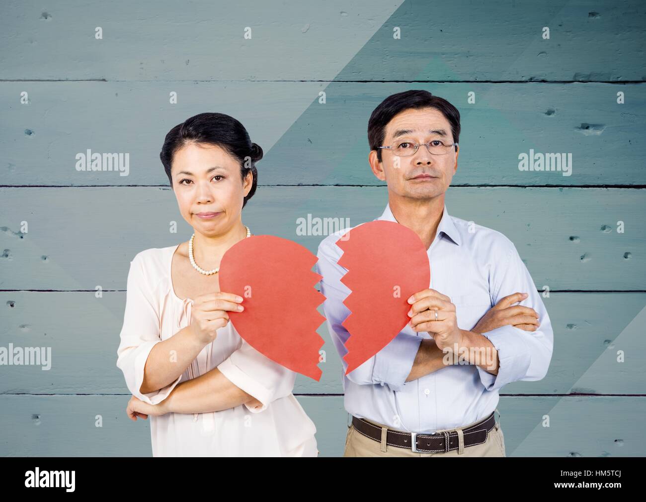 Sad couple holding broken heart Stock Photo - Alamy