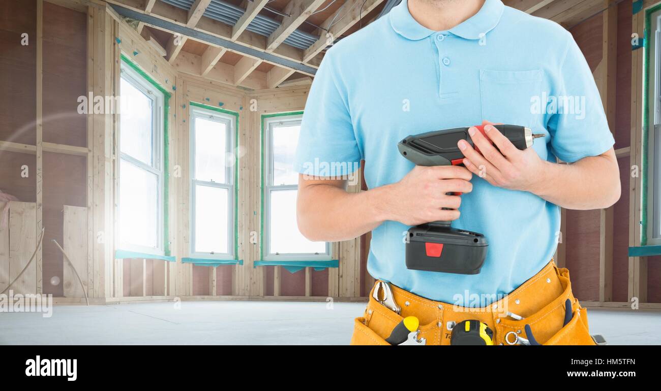 Mid section of handyman with tool belt and drill machine Stock Photo ...