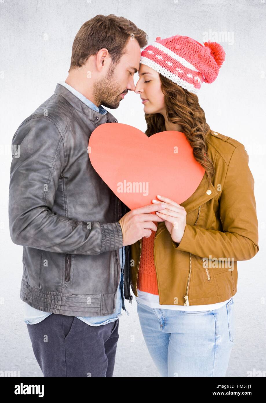 Romantic couple with face to face holding heart Stock Photo - Alamy