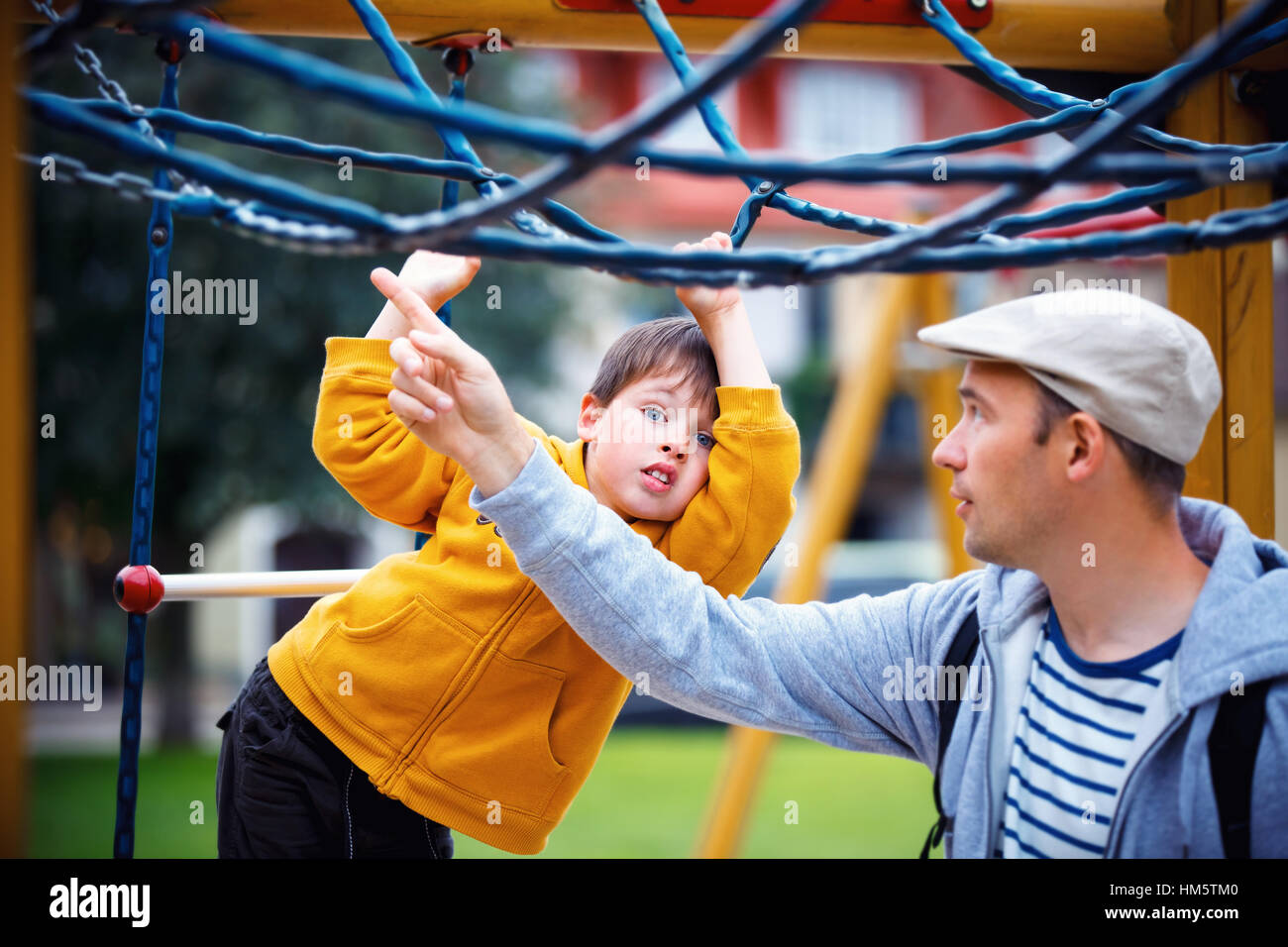 Cute little boy and his father at a playground Stock Photo - Alamy
