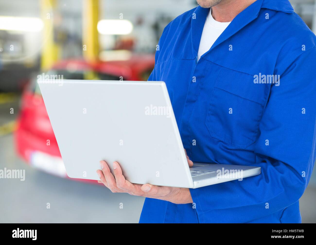 Mechanic using laptop in workshop Stock Photo - Alamy