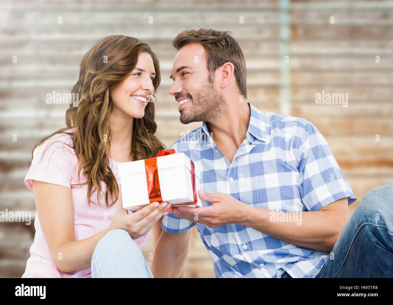 Man giving a gift to woman Stock Photo - Alamy
