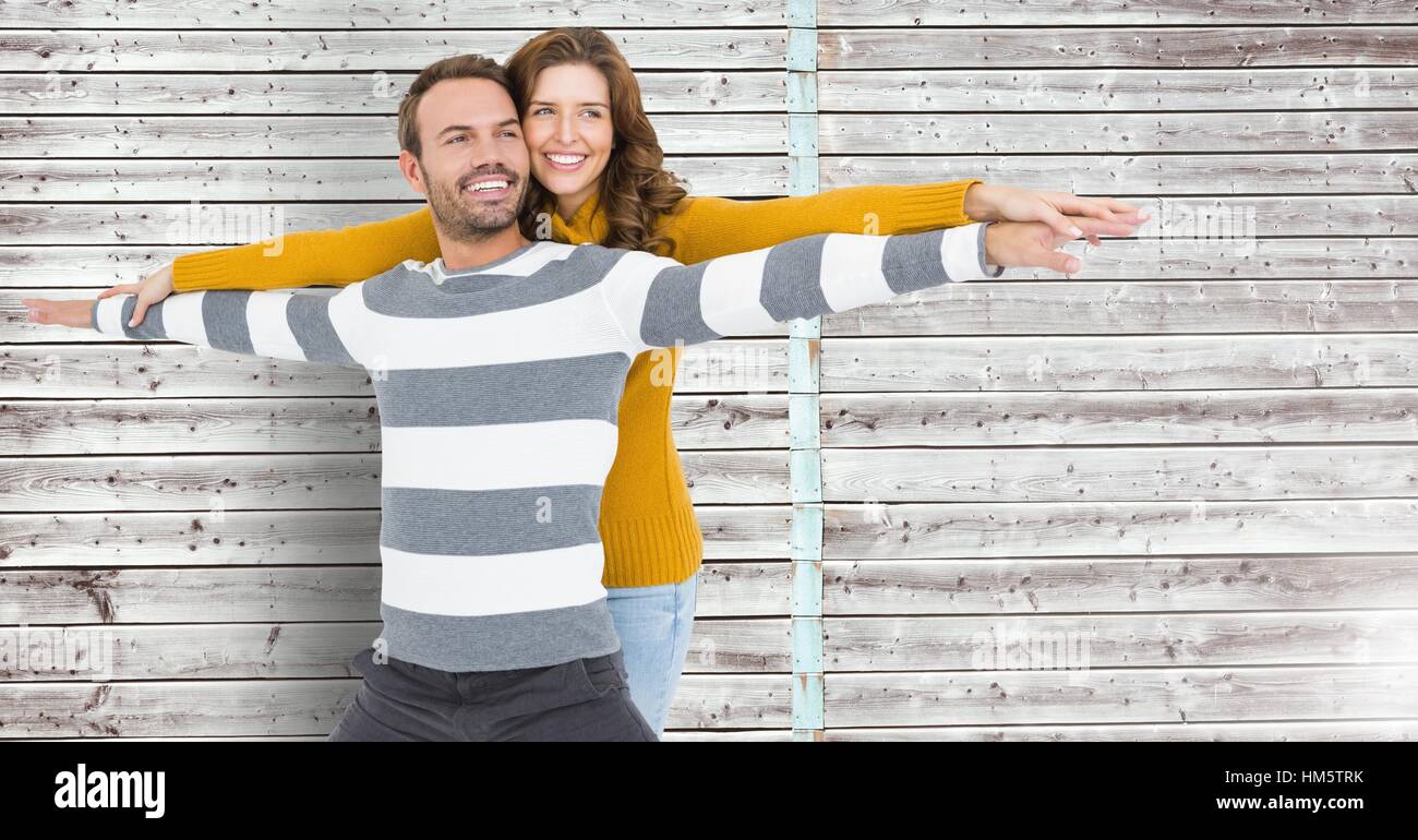 Happy couple standing with arms outstretched Stock Photo - Alamy